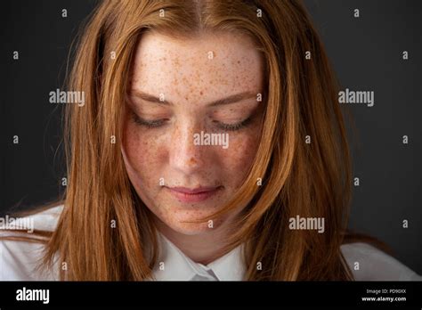 Close Up Of A Red Headed Girl With Freckles With Her Eyes Closed Stock
