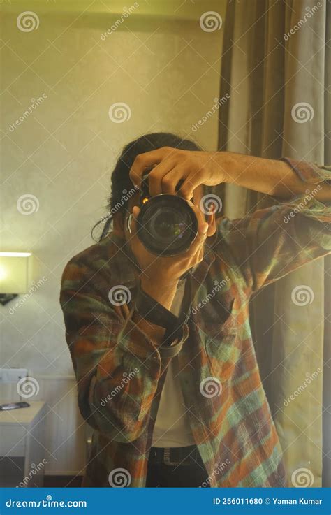 A Male Photographer Taking Selfie With His Dslr Camera In Front Of