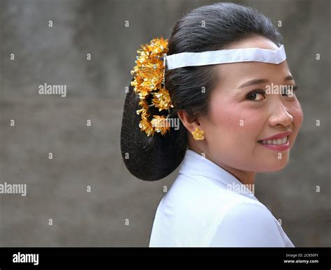 Young Indonesian Balinese Woman Wears White Outfit And Smiles For The