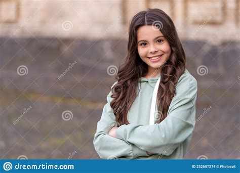 Confident Teenage Girl Happy Smiling In Casual Hoodie Keeping Arms