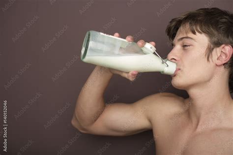 Young Naked Man Drinking Milk From A Bottle Close Up Portrait Stock