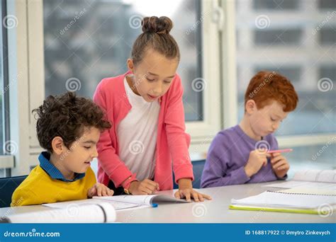 Niña De Escuela útil Explicando La Tarea A Los Compañeros De Clase Foto