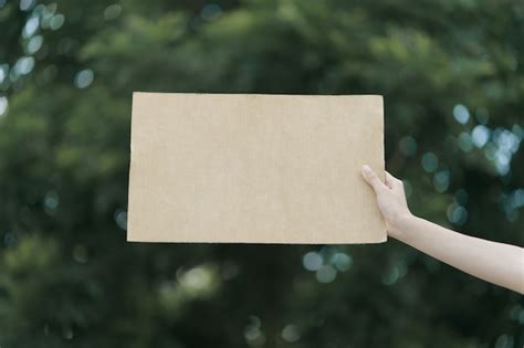 Premium Photo Womans Hands Holding A Blank Placard To Put The Text