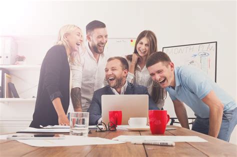 Happy Diverse Office Workers Team Laughing Together At Group Meeting