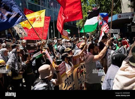 A Diverse Crowd Of Protesters Of All Ages And Genders Hold A Banner In