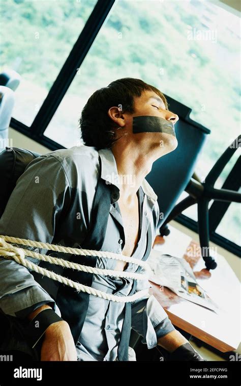 Man In Tuxedo Tied To A Chair And Gagged With Duct Tape Hoodoo Wallpaper