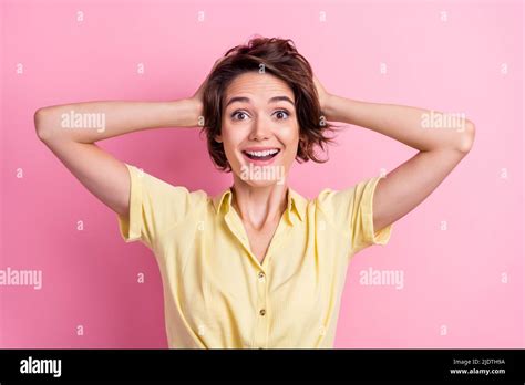 Photo Of Impressed Millennial Brunette Lady Hands Head Wear Yellow T