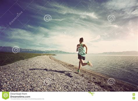 Fitness Woman Runner Running On Sunrise Seaside Trail Stock Image