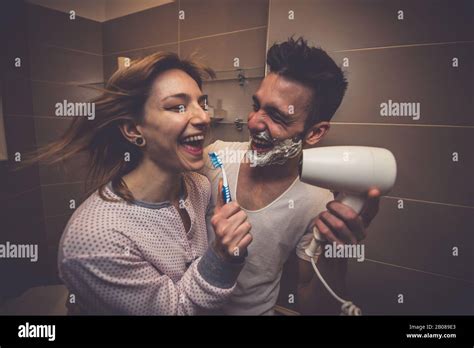 Couple Morning Routine Man And Woman Sharing Bathroom Shaving Beard