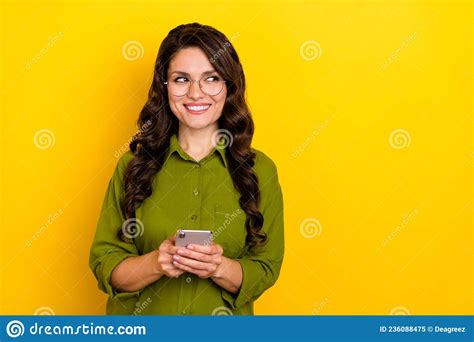 Photo Of Curious Dreamy Lady Hold Telephone Look Empty Space Wear Green