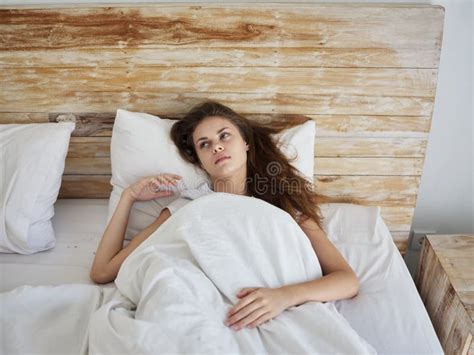 Woman Lies In Bed Under The Blanket In The Morning Relaxation Emotions