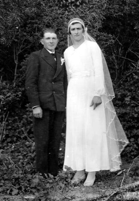 An Old Black And White Photo Of A Man And Woman In Wedding Attire