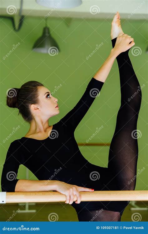 Elegant Beautiful Ballerina With A Perfect Body Doing Stretching