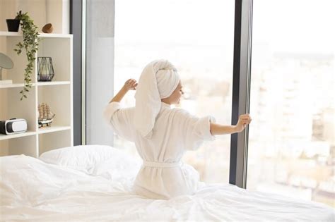 Premium Photo Lady In Robe Pulling Hands Aside On Bed At Home