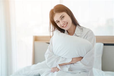 Photo Of Young Happy Woman In Pajama Stretching Her Arms And Smiling