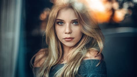 Girl Model Is Standing In Blur Bokeh Background Wearing Dark Grey Dress
