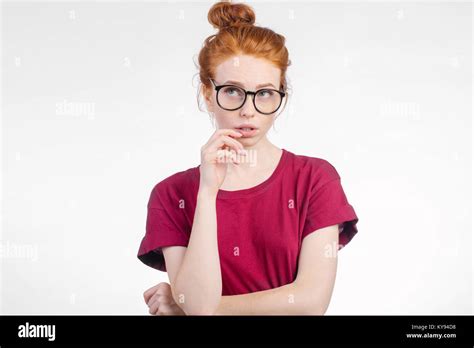 Redhead Girl Wearing Glasses With Hair Knot And Freckles Looking