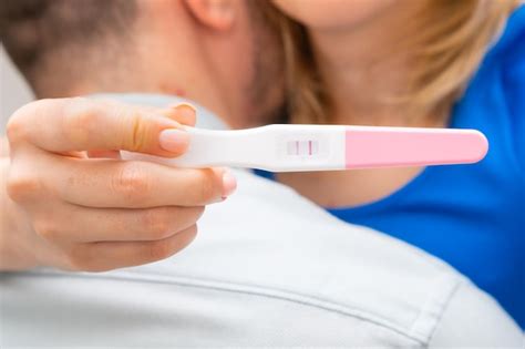 Premium Photo Woman Hugging Man And Holding Positive Pregnancy Test