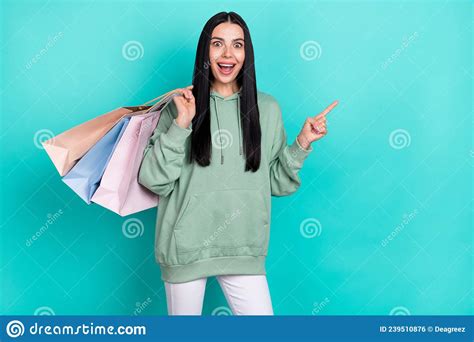 Photo Of Hooray Young Brunette Lady Indicate Promo Hold Bags Wear Green