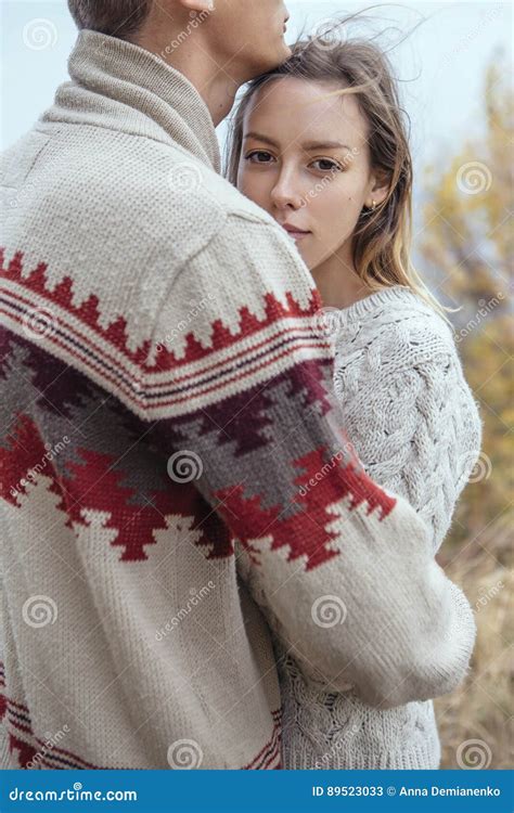 Happy Thoughtful Couple Standing On A Cliff Near Sea Hugging Each Other
