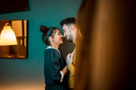 Heureux Homme Embrassant Une Femme Joyeuse Dans La Chambre Photo Gratuite
