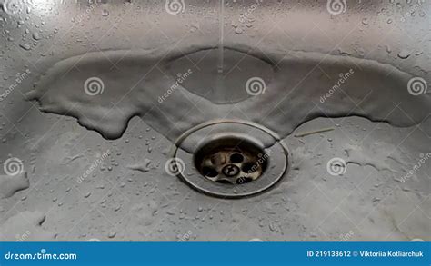 Water Flows From The Tap In The Kitchen Sink Close Up Of The Kitchen