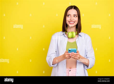 Photo Of Cute Brunette Millennial Lady Hold Telephone Look Empty Space