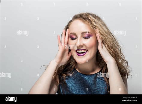 Beautiful Curly Girl With Bright Makeup Laughing With Eyes Closed