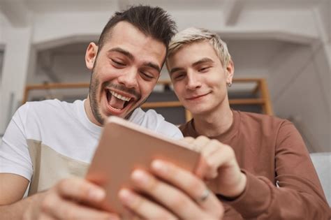 Premium Photo Low Angle Portrait Of Two Young Men Laughing While