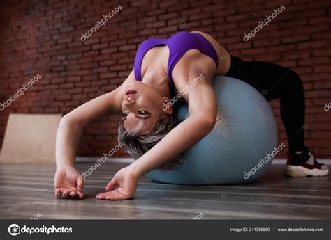 Woman Doing Exercises With Fitball In Fitness Gym Class Engaging Core