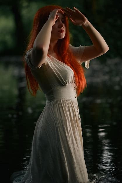 Premium Photo Beautiful Redhaired Girl In A White Dress In The Lake