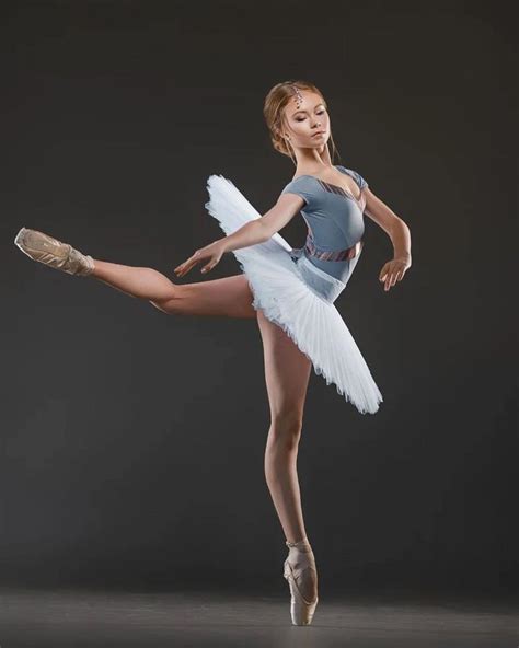 A Young Ballerina Is Posing For The Camera With Her Legs Spread Out And