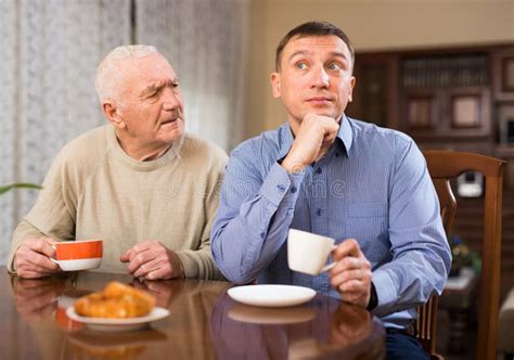 Man And His Adult Son Drinking Tea Stock Image Image Of Casual