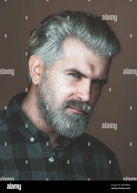Mature Blonde Bearded Guy With Trendy Hairdo In Casual Shirt Smiling
