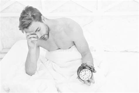 Man Waking Up Early Morning Ringing Alarm Clock Exhausted Concept