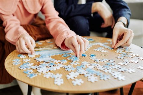 Premium Photo Close Up Of Father And Daughter Playing Puzzle Game