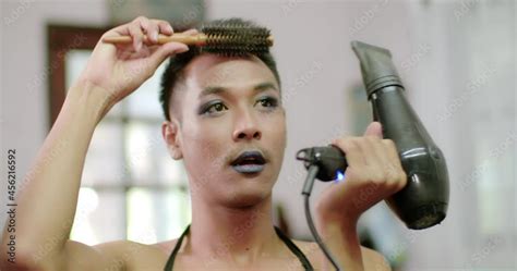 A Smiling Short Haired Asian Gay Who Owns A Small Beauty Salon In The