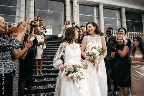 Candid Shot Of Two Female Lesbian Lgbt Brides Walking Down The Stairs