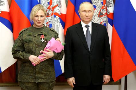 Why Does Mystery Blonde Keep Popping Up In Putin Photo Ops