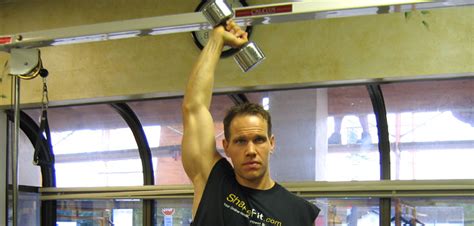 standing one arm dumbbell extension triceps exercise guide
