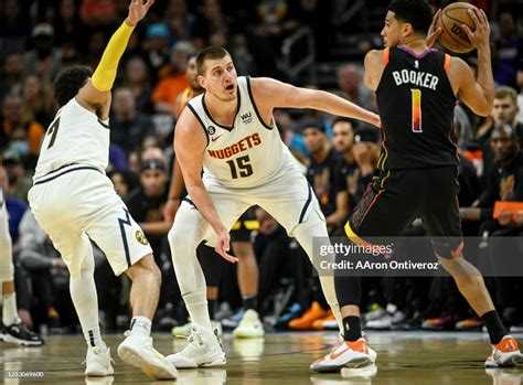 Nikola Jokic Of The Denver Nuggets And Jamal Murray Defend Devin