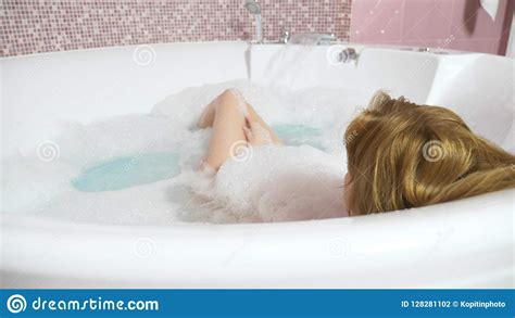 Beautiful Young Woman Relaxes In A Bath With Hydromassage On A Blue