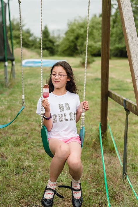 Beautiful Mixed Race Tween Girl Enjoying An Ice Lolly By Stocksy