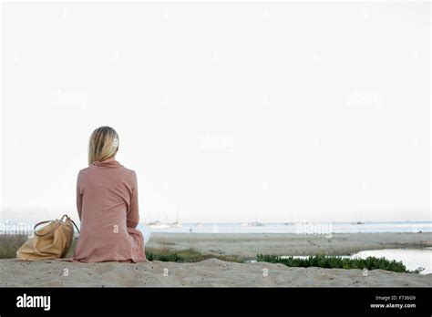 Femme Blonde Assise Sur Une Plage De Sable Banque De Photographies Et D