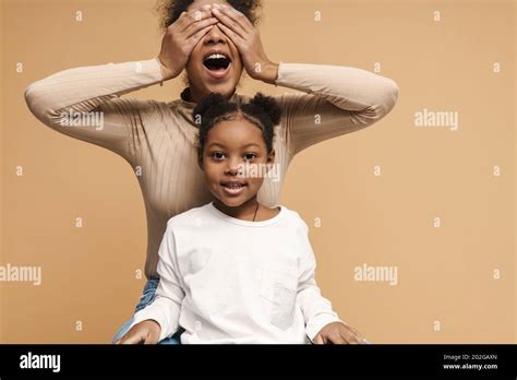 Happy Black Mother And Daughter Covering Eyes While Making Fun Isolated