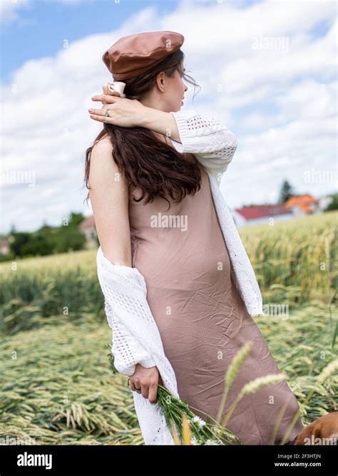 European White Girl On Wheat Field Standing Facing Away From The Camera