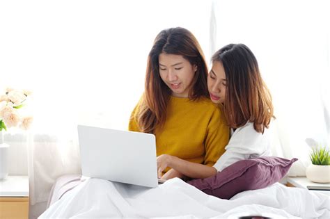 Young Cute Asia Woman Lesbian Couple Using Laptop Computer With