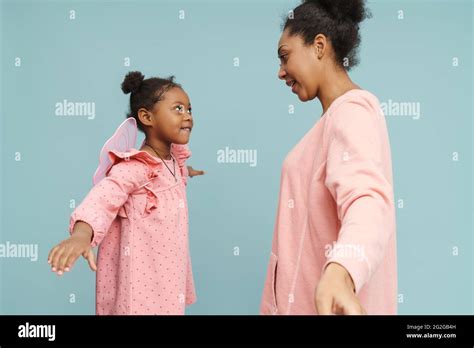Happy Black Mother And Daughter With Butterfly Wings Making Fun