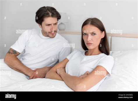 Unhappy Millennial European Guy Calm Offended Woman With Crossed Hands