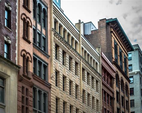 Row Of Brick And Brownstone New York City Apartments Seen From Outside